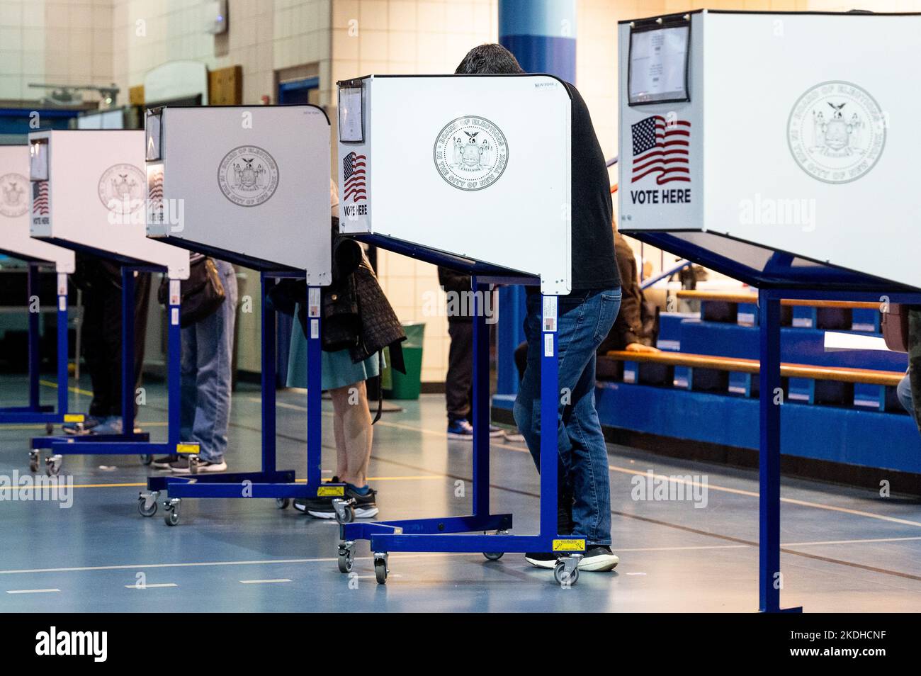 Voters marking their ballot in a privacy booth at West Side High School ...
