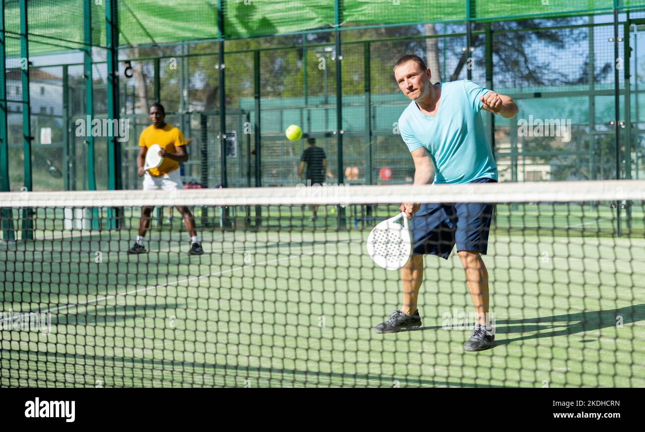 Male padel tennis player training on court Stock Photo - Alamy