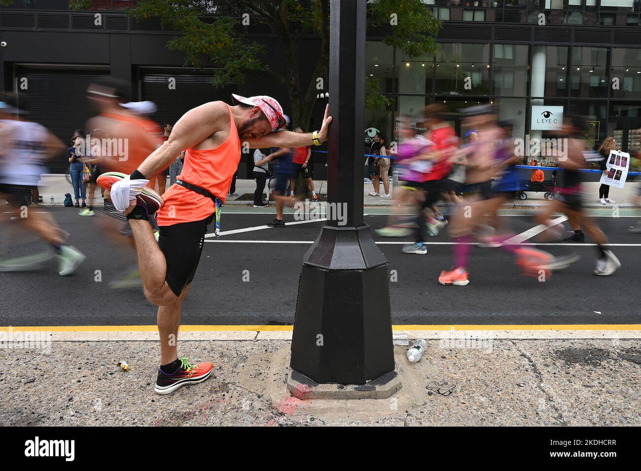 Jose Segovia from Mexico grimaces as he stretches his leg muscle during ...