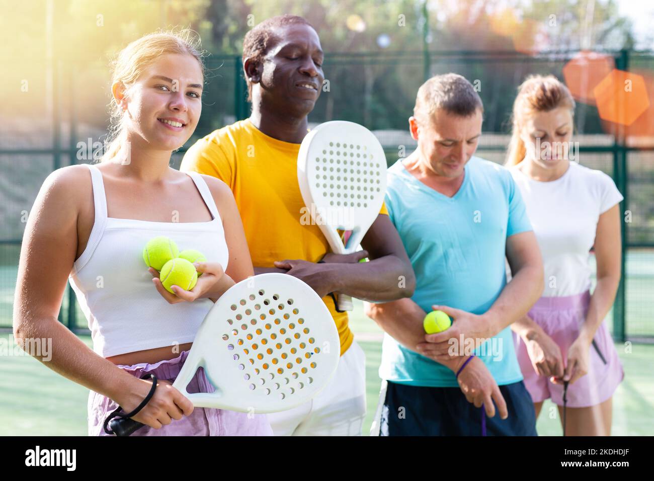 Group photo of positive people on padel tennis court Stock Photo - Alamy
