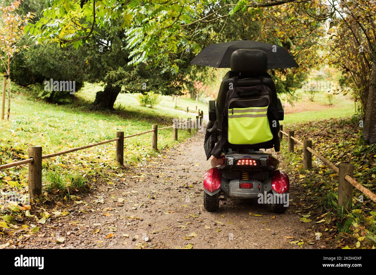 person on a mobility scooter outside in the rain Stock Photo - Alamy