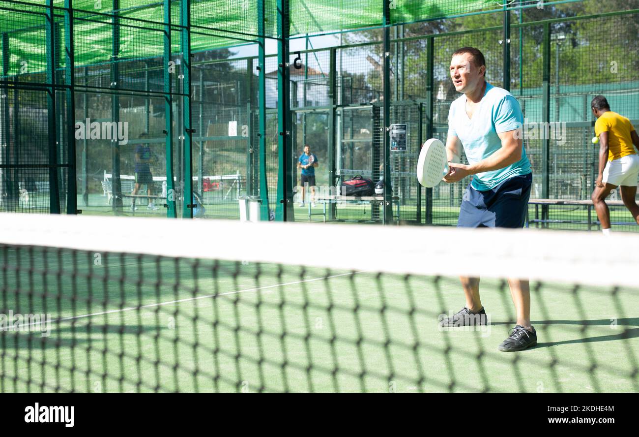 Male padel tennis player training on court Stock Photo - Alamy