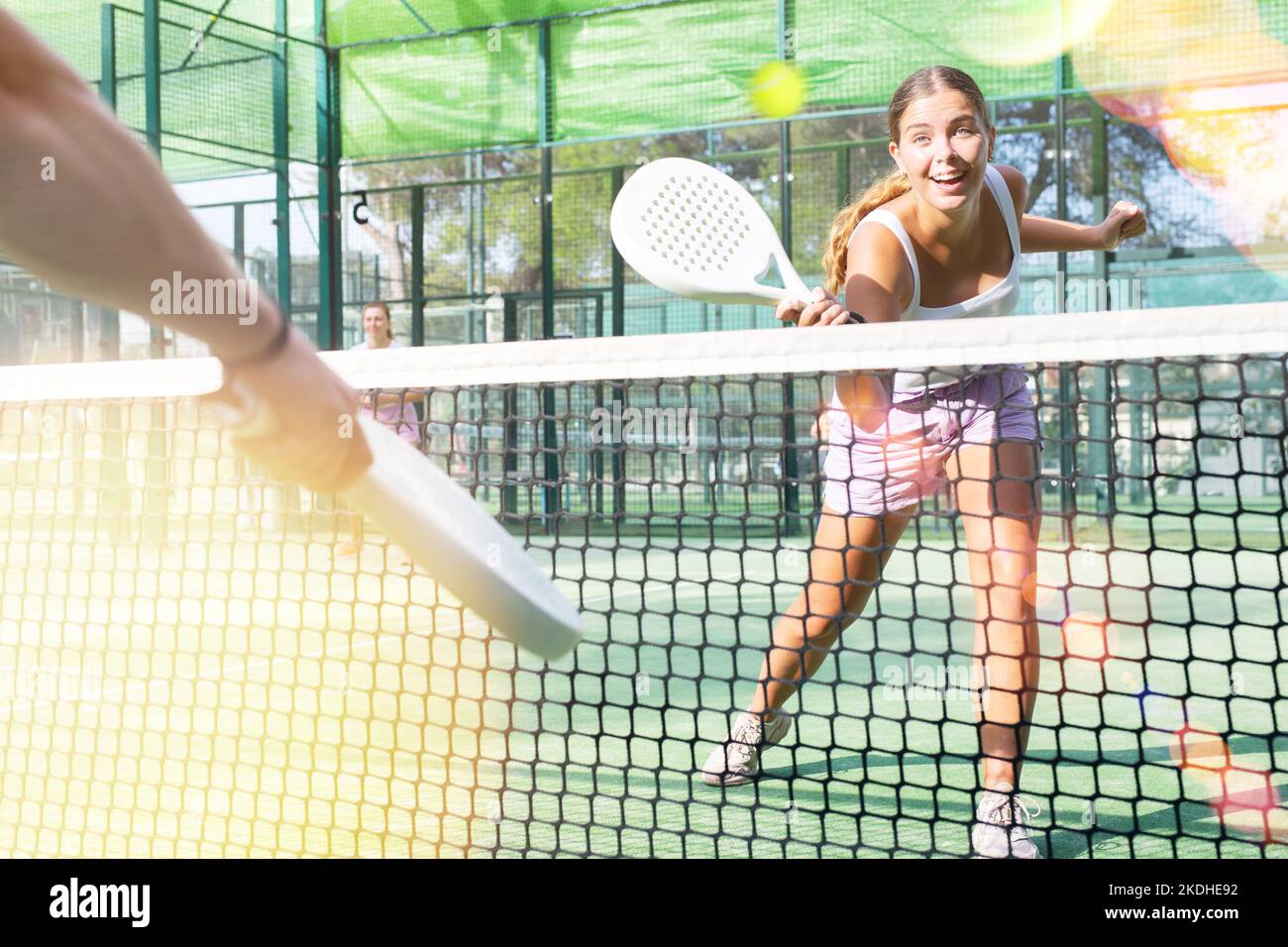 Young woman padel tennis player trains on the outdoor court Stock Photo ...