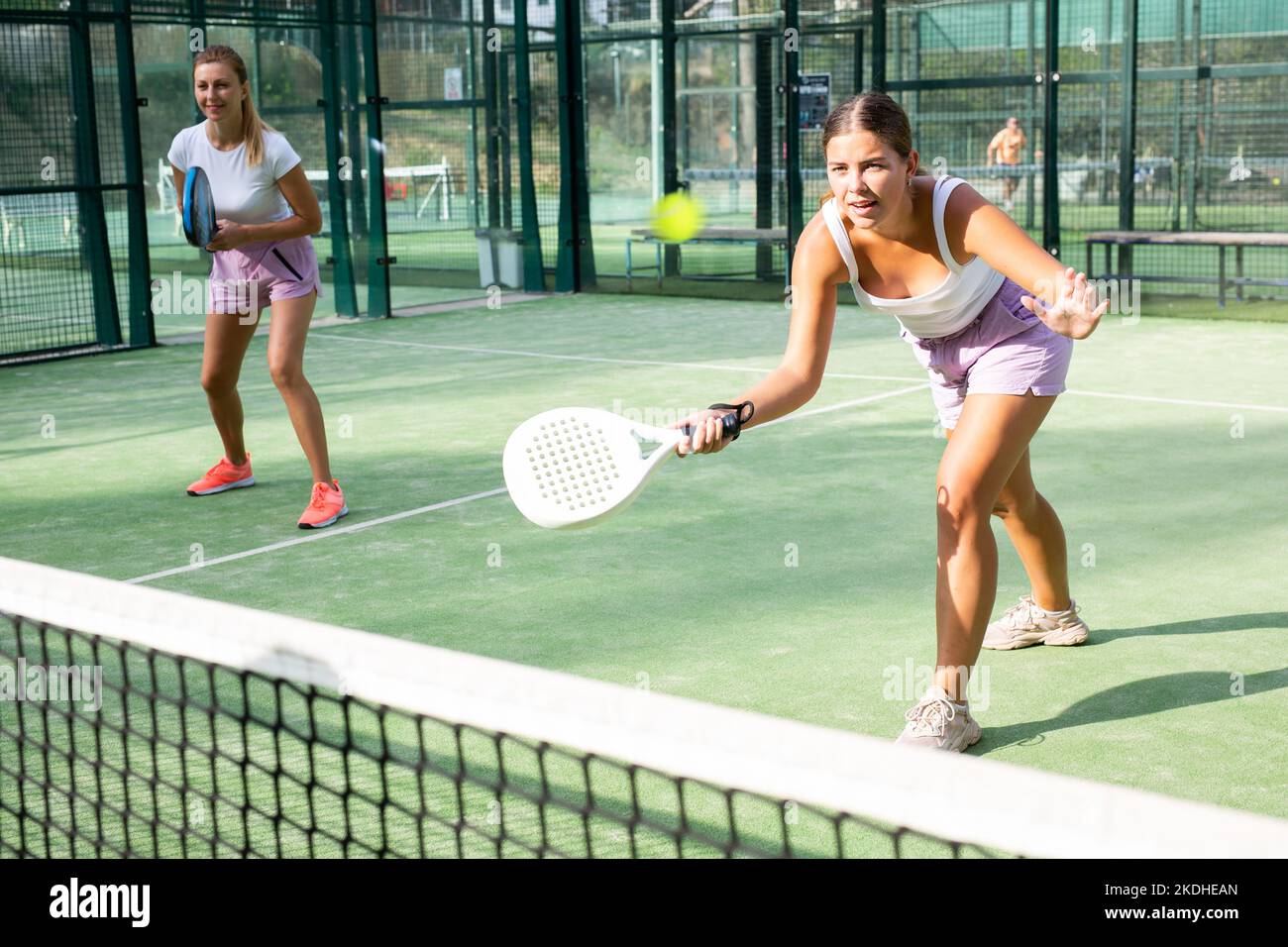 Two women tennis players playing padel Stock Photo - Alamy