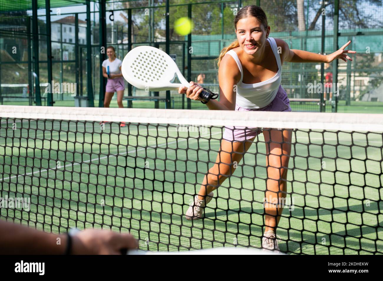 Young woman padel tennis player trains on the outdoor court Stock Photo ...