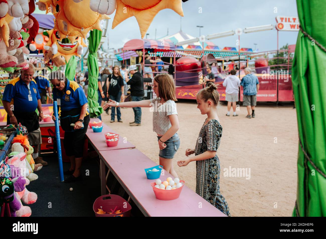Girls playing a carnival game at local fair Stock Photo - Alamy