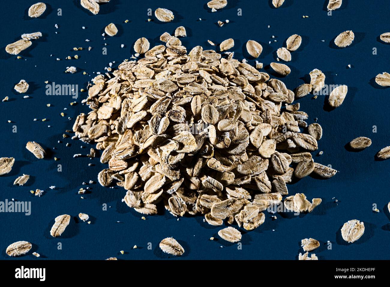 Oatmeal oat oats rolled haver flakes porridge bunch heap on blue ...
