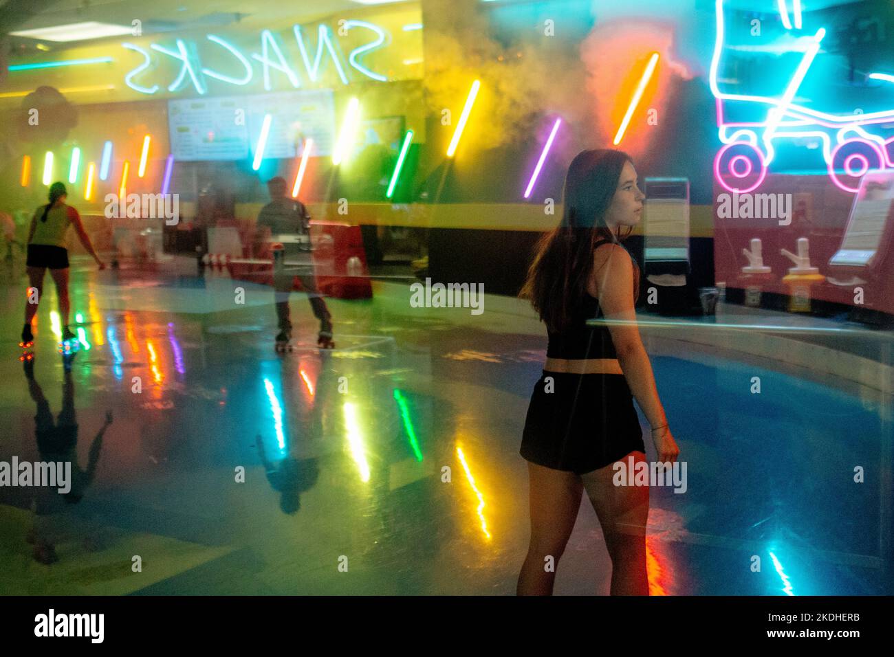 Teen girl roller skating at a trendy roller rink Stock Photo - Alamy