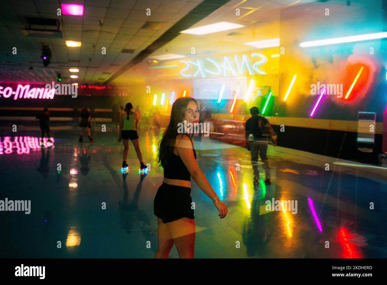 Teen girl roller skating at trendy roller rink Stock Photo - Alamy