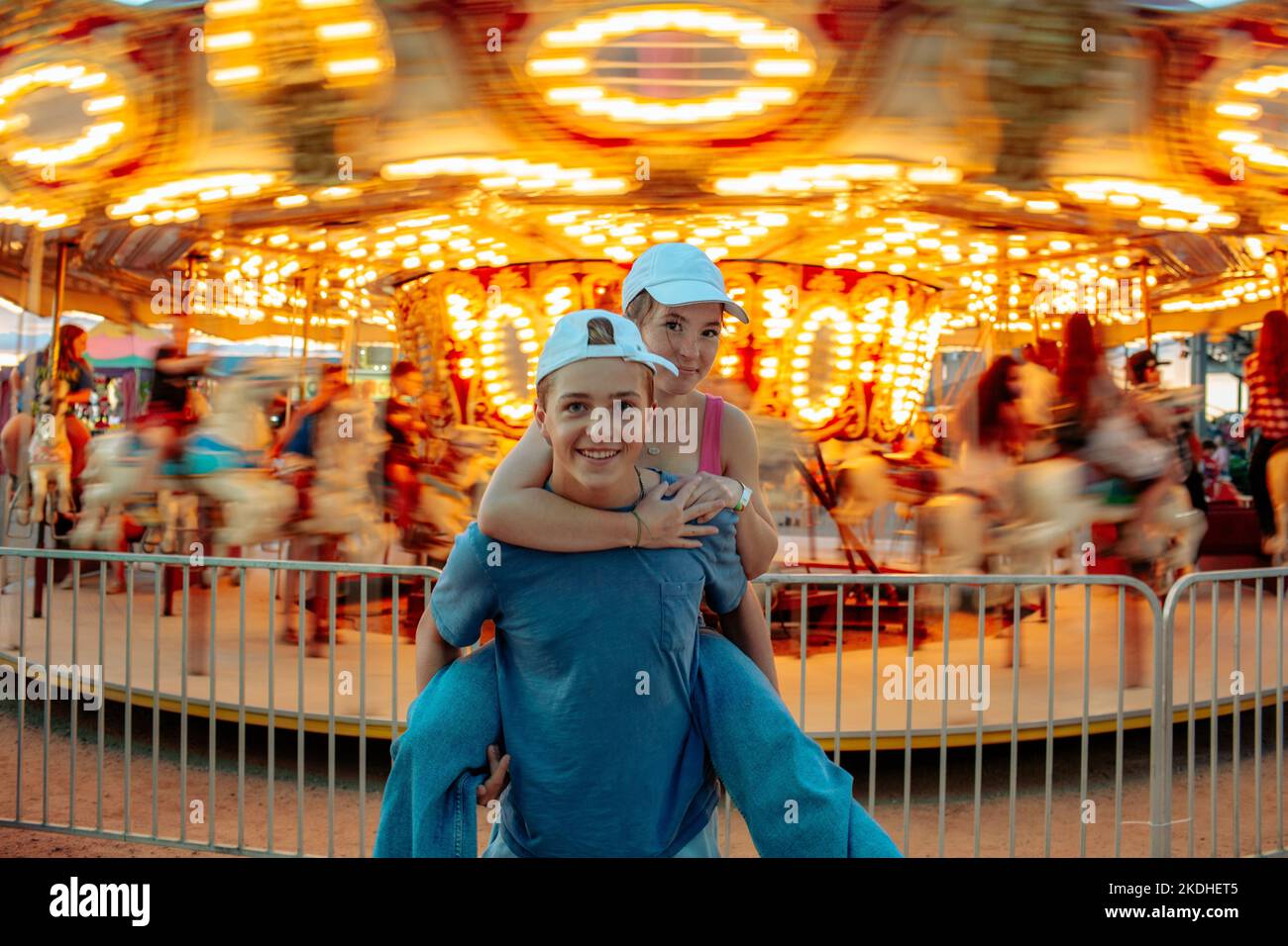 teens having run in front of a moving carousel Stock Photo - Alamy