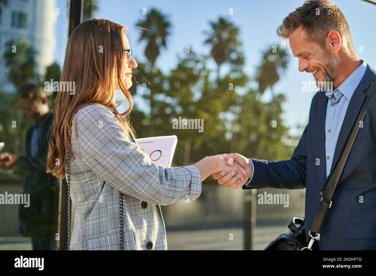 Business people dressed in formal wear shaking hands Stock Photo - Alamy