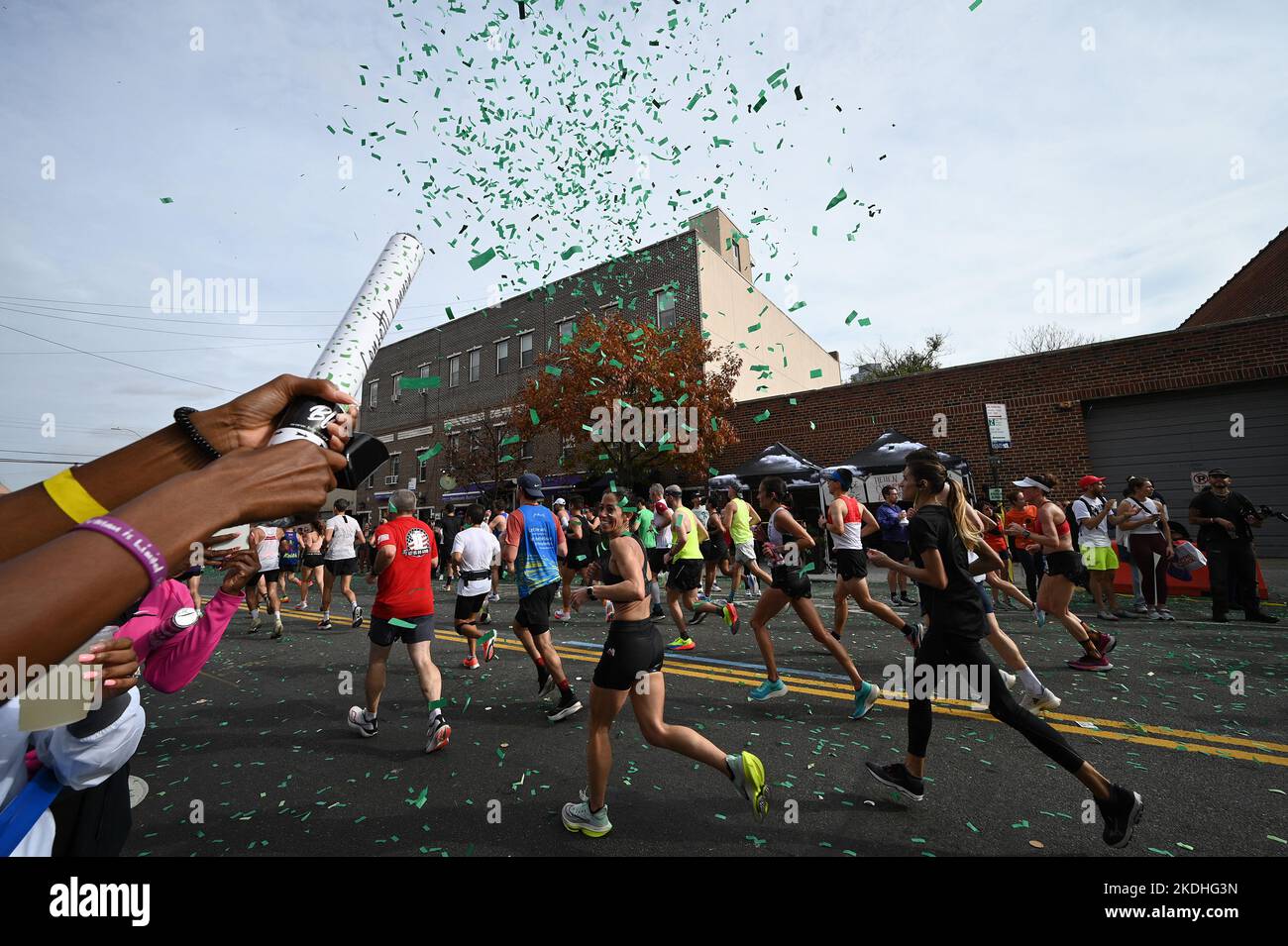 Runners are met with confetti poppers as they crowds cheer them on ...