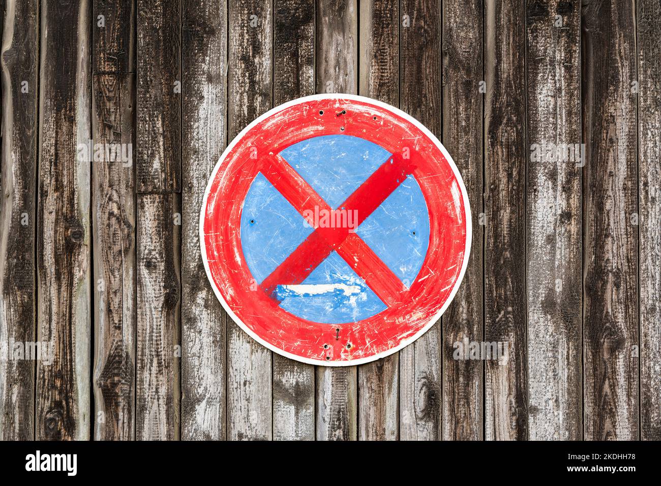 Hand-painted no parking sign (parking prohibition) on a weathered ...