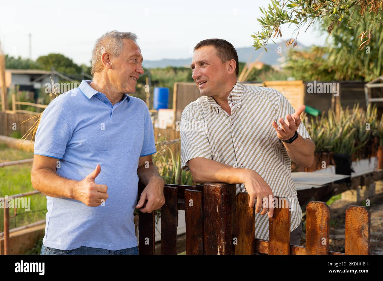 Neighbors talking fence hi-res stock photography and images - Alamy