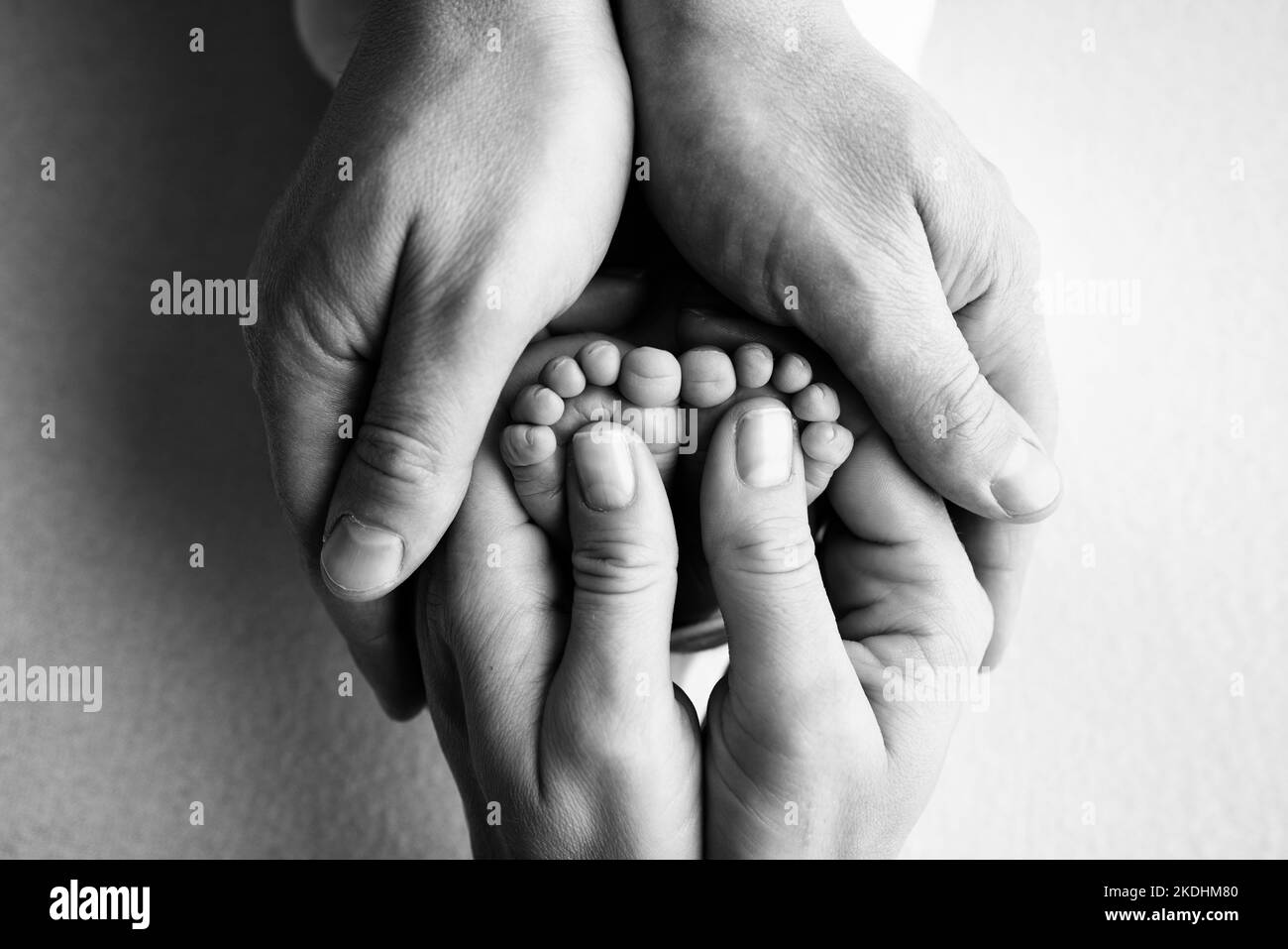 The palms of the parents holds the feet of the newborn child Stock ...