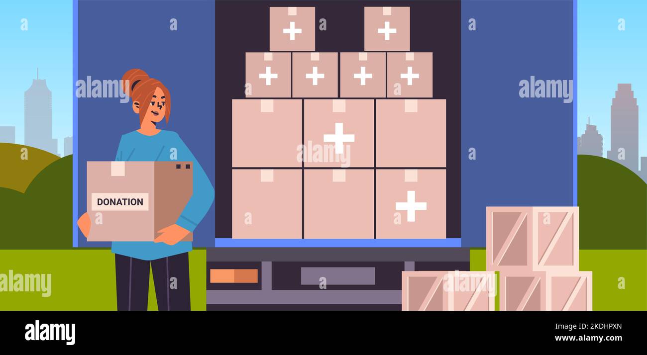 young woman loading donation help box with medical supplies ...