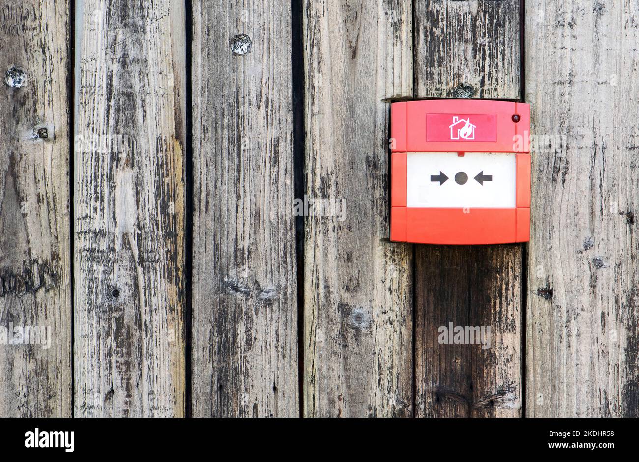 Red Fire alarm on the wooden wall background Stock Photo - Alamy