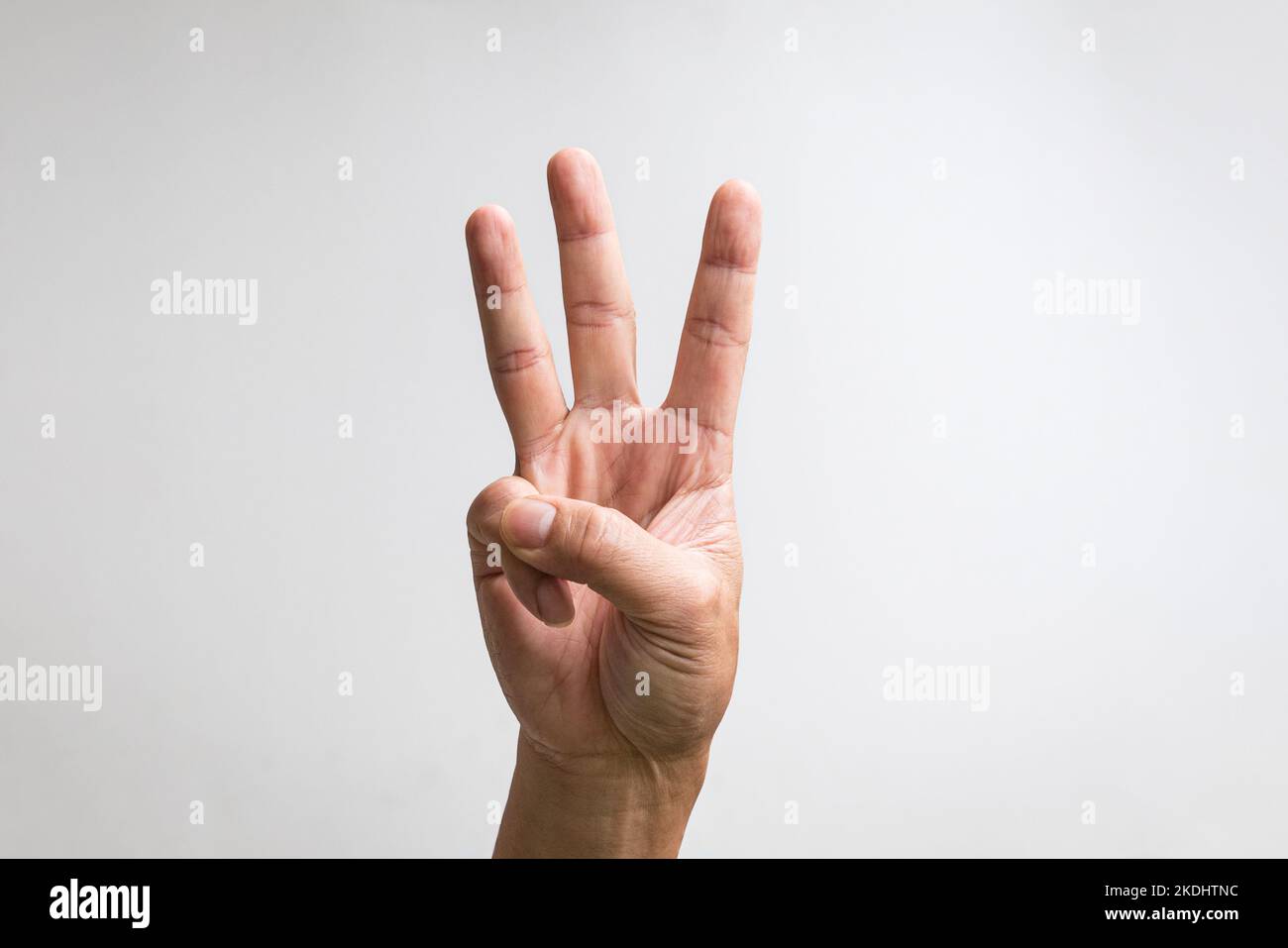 Pointing up with fingers number three. Close up, isolated on white ...