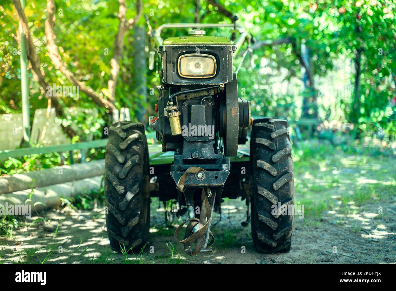 Old walk-behind tractor for tillage in agriculture close-up on a framed ...