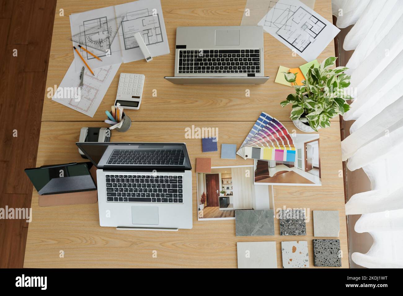 Documents with house plan, samples of tile and wall paint and laptop on ...