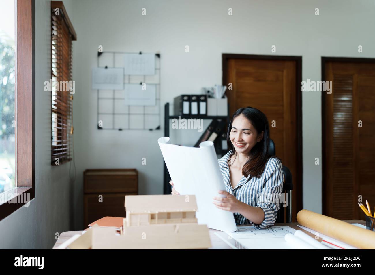 Portrait of an Asian female engineers are designing house structures ...