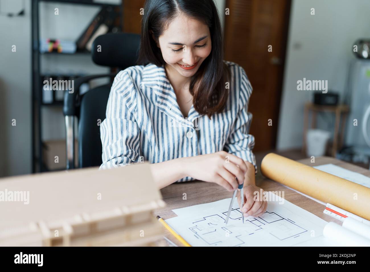 Portrait of an Asian female engineers are designing house structures ...