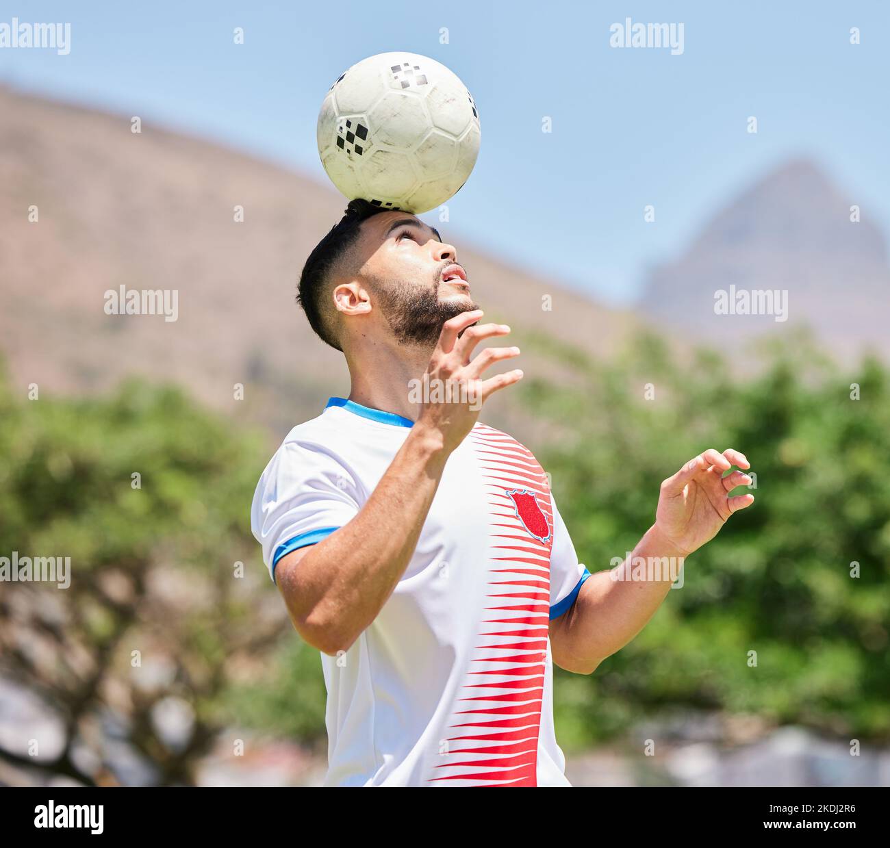 Sports, soccer and man soccer player training, balance and ball, head ...
