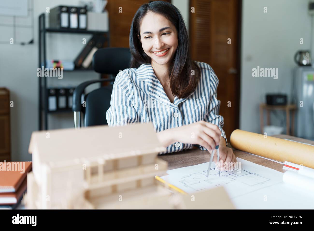 Portrait of an Asian female engineers are designing house structures ...