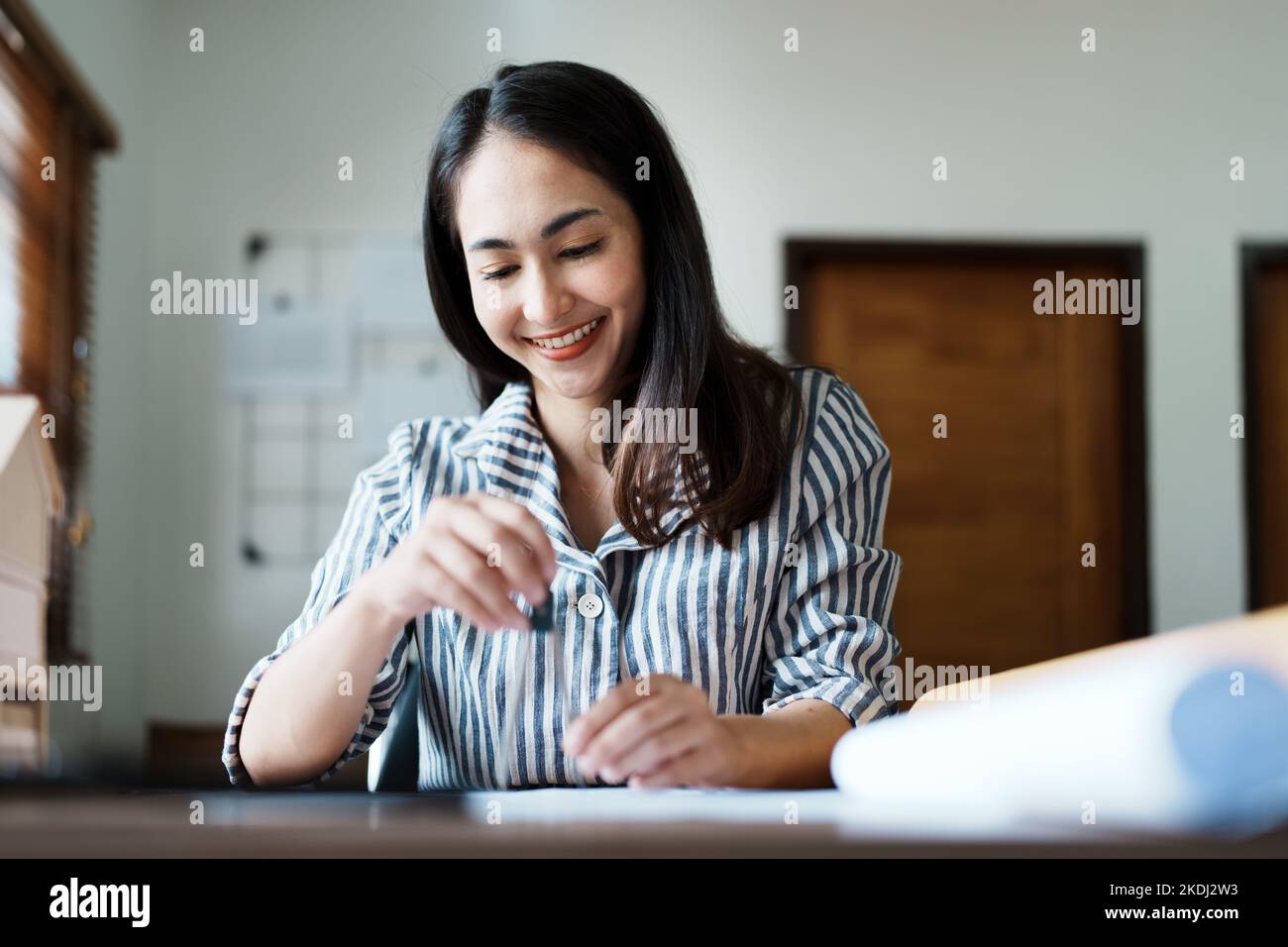 Portrait of an Asian female engineers are designing house structures ...