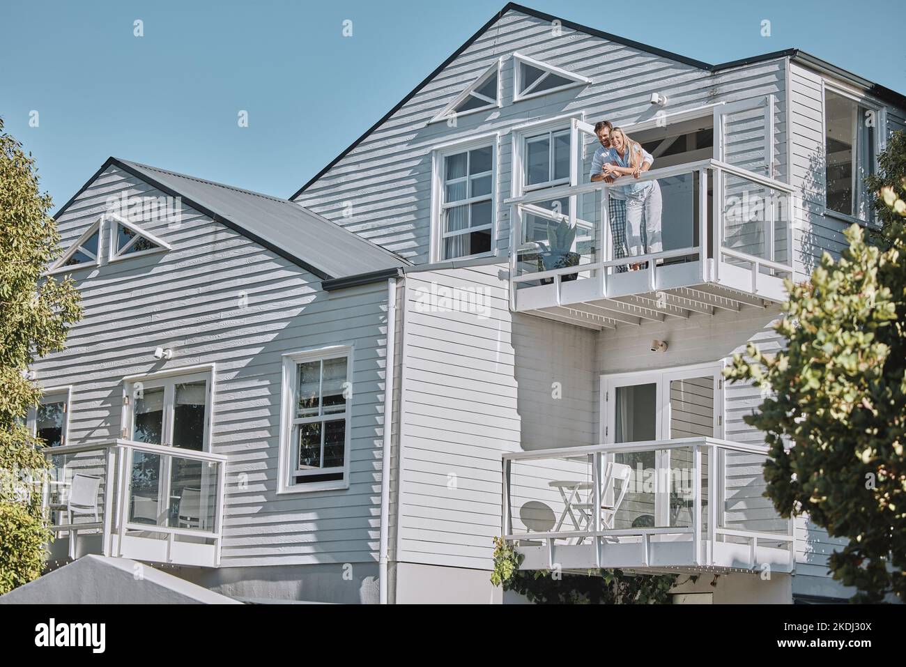 Real estate, house and couple relax on balcony of their dream home ...