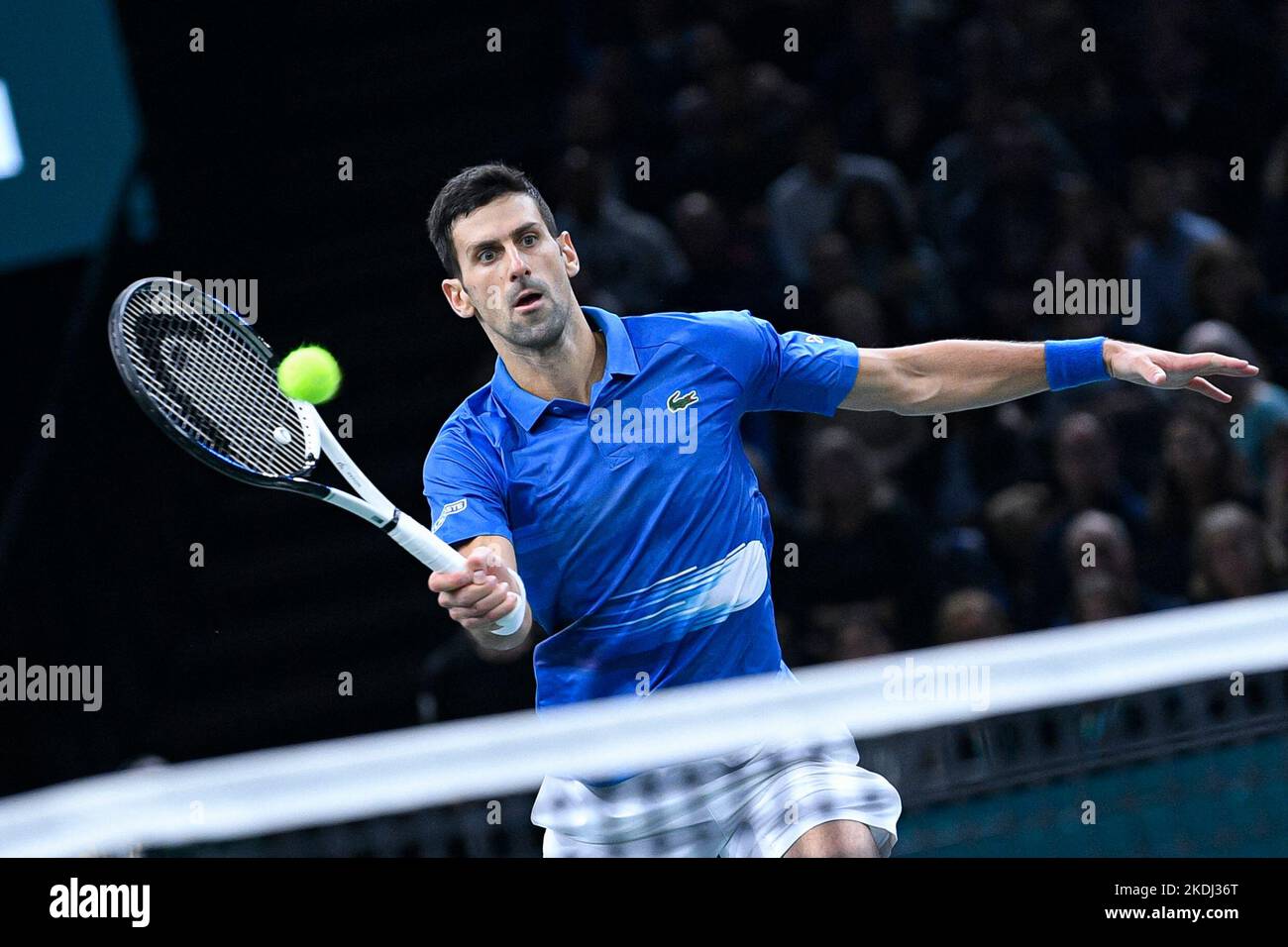 Novak Djokovic of Serbia hits a volley during the final against Holger ...