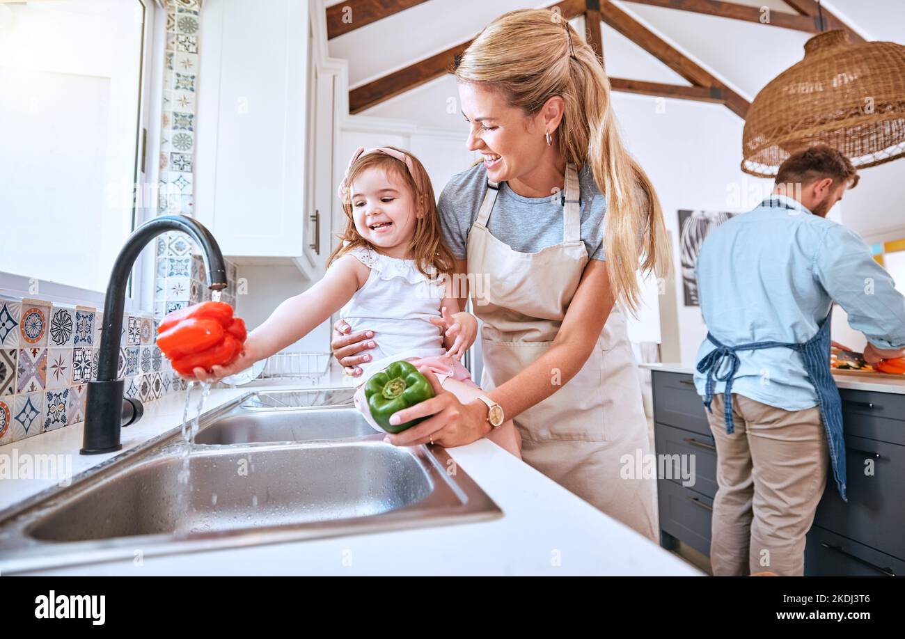 Kid, washing vegetables and cooking with mother together with healthy ...