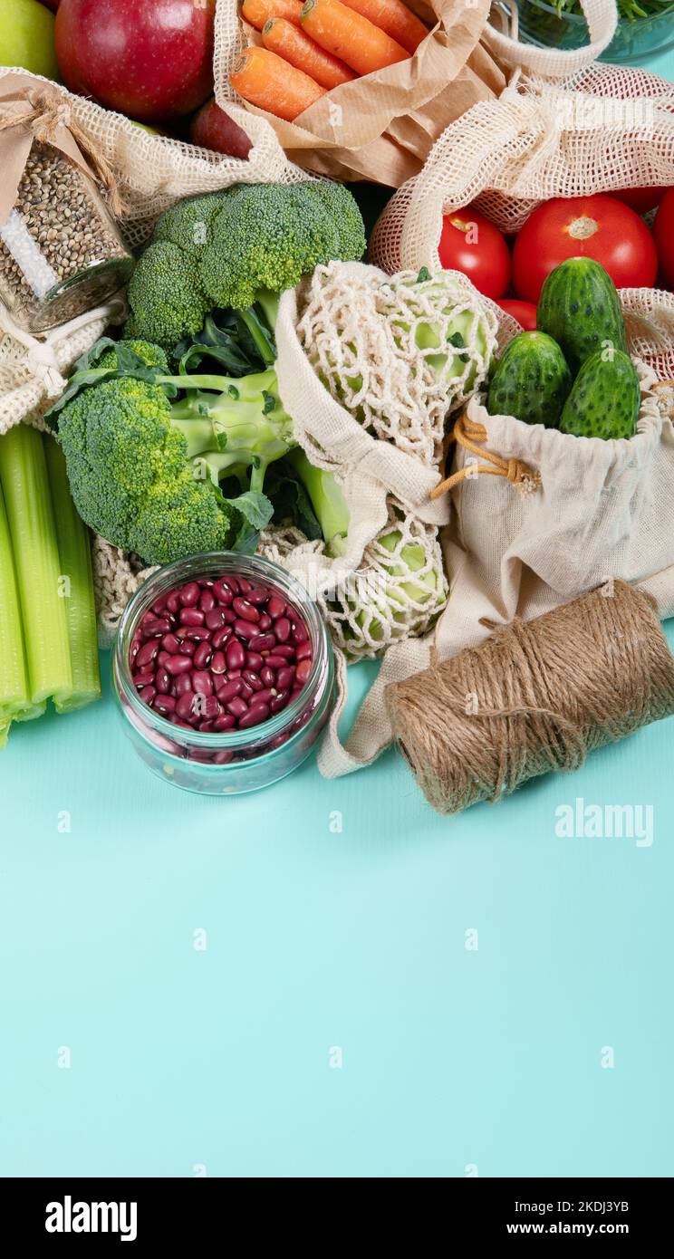 Various organic fruits and vegetables in reusable packaging bags. Eco ...