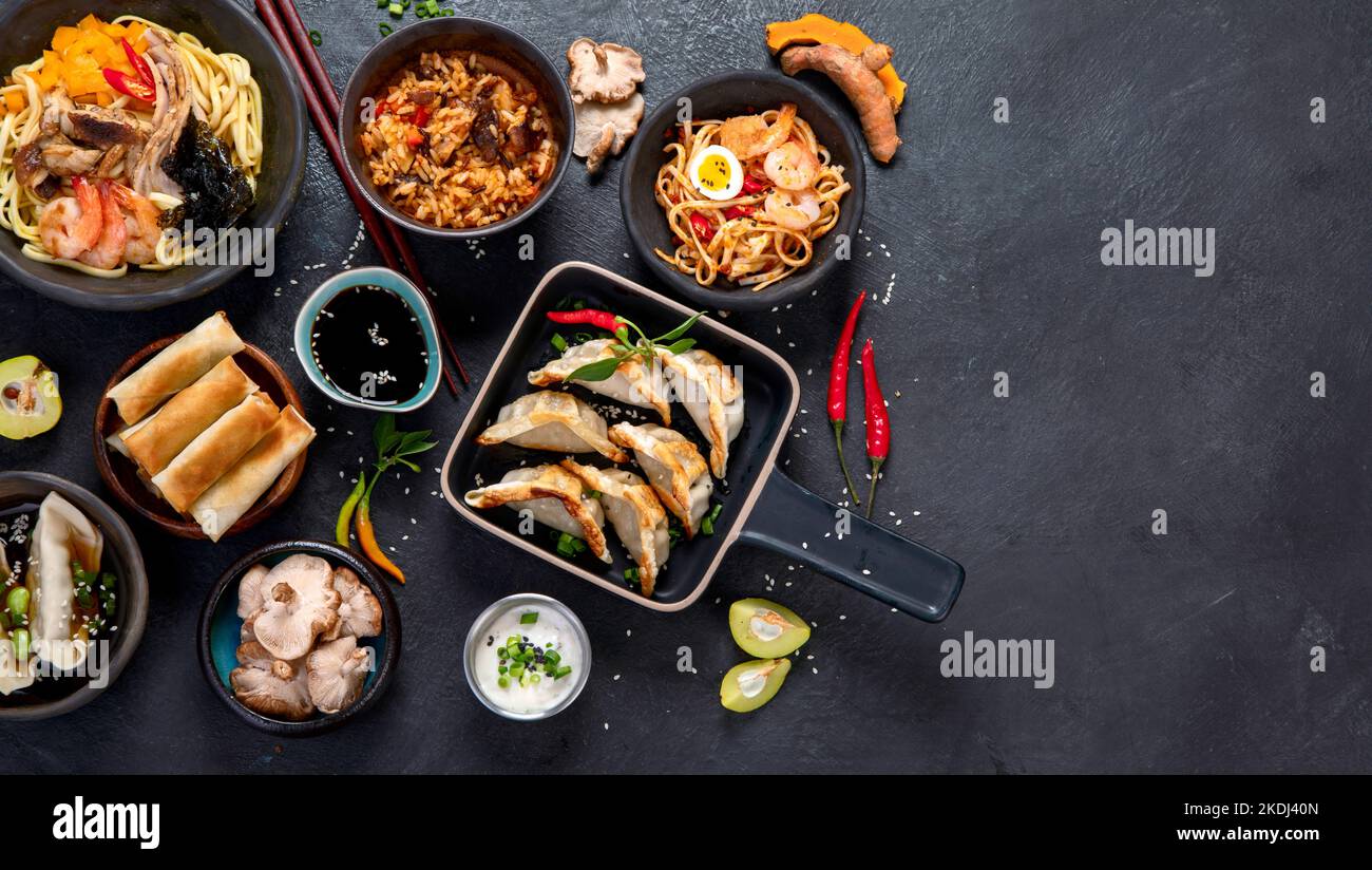 Traditional Asian food. Various of asian meals on dark background ...