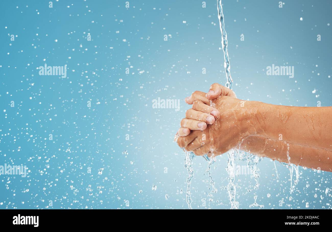 Water splash, cleaning hands and hygiene on blue background ...