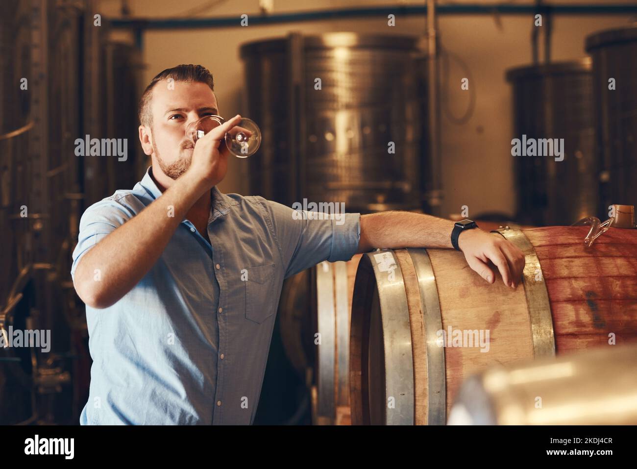 Delight your senses. a handsome young man enjoying wine tasting in his ...