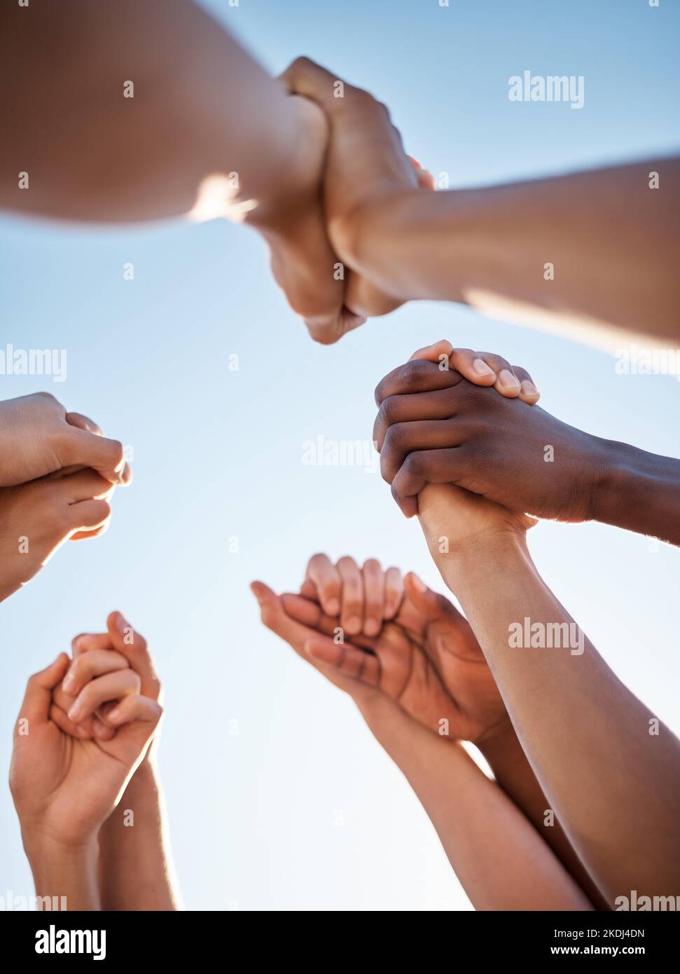 Low angle, group and holding hands in support, trust huddle and ...