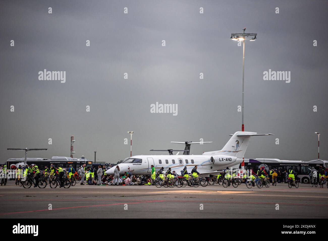 Activists ride at the wheel, as they circle the private jets at ...