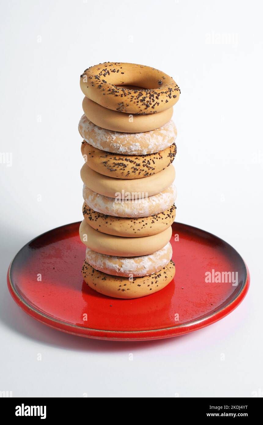 Stack of various bagels on a red plate on a white background Stock ...