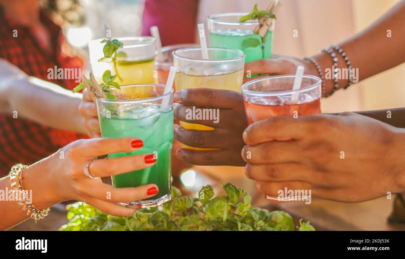 Happy people cheering with mojito and having fun - Multiracial friends ...