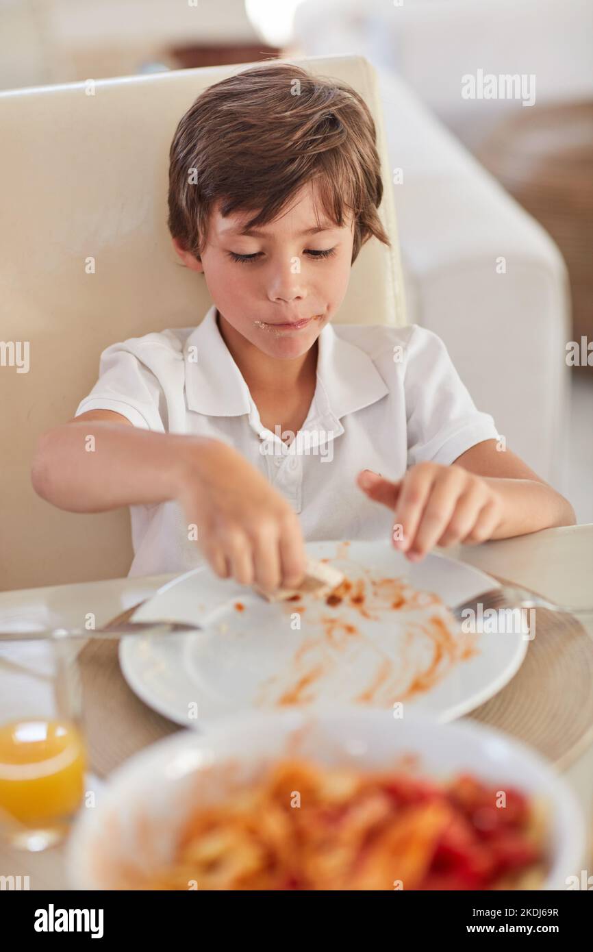 One word yum. a happy little boy enjoying lunch on his own at home ...