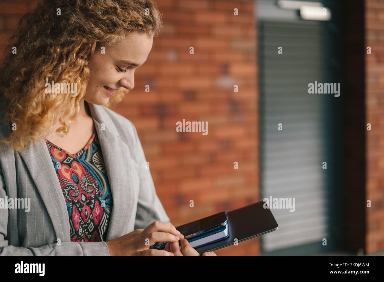 Smiling student checking mail and reading notification on smartphone ...