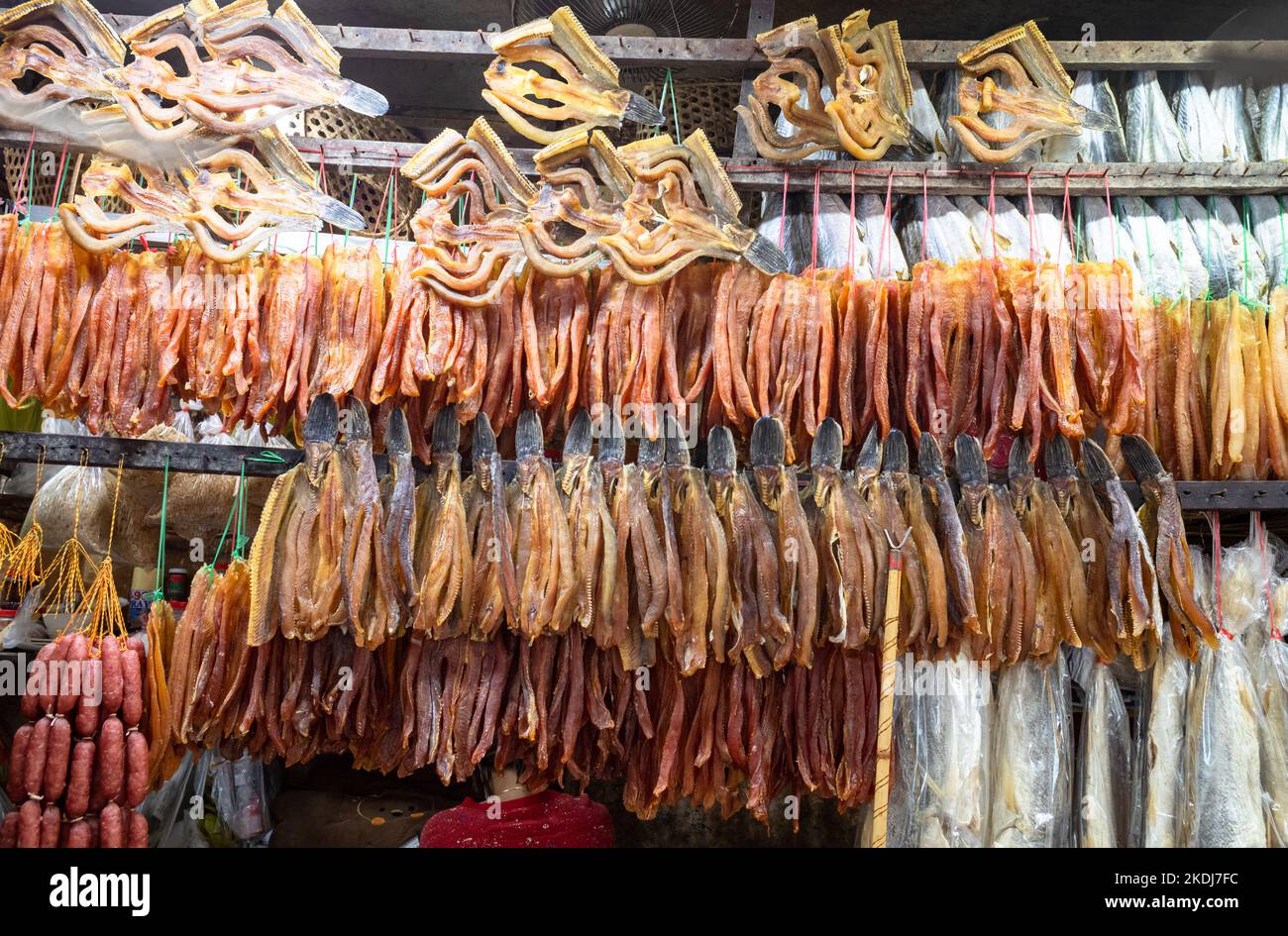 Dried fish and meat hanging on display at a stall in Siem Reap Market ...