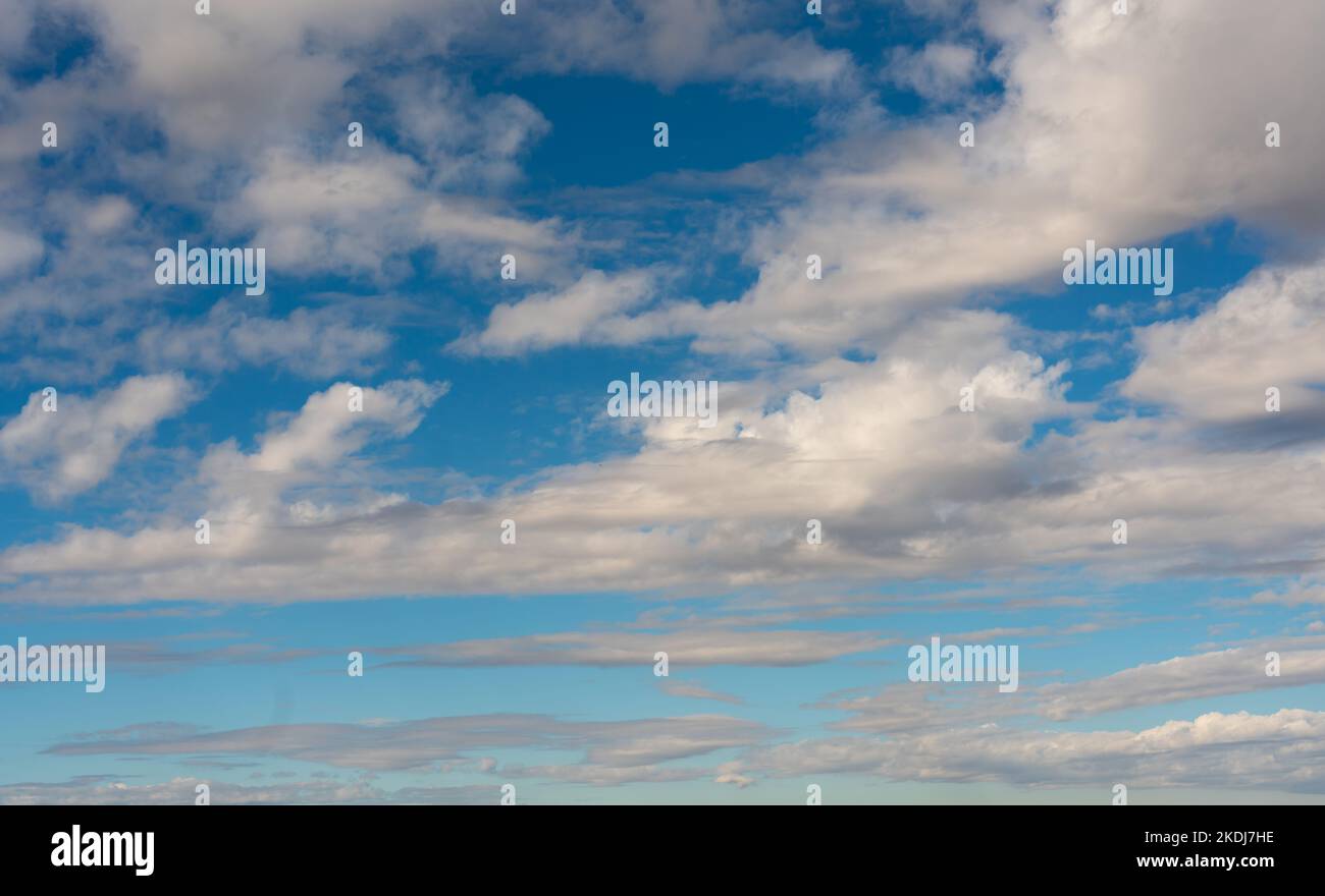 Beautiful blue sky with a scattering of horizontal clouds Stock Photo ...