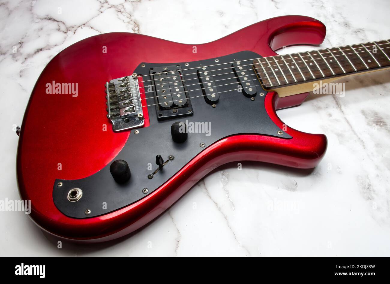 Red electric guitar isolated on marble background Stock Photo - Alamy