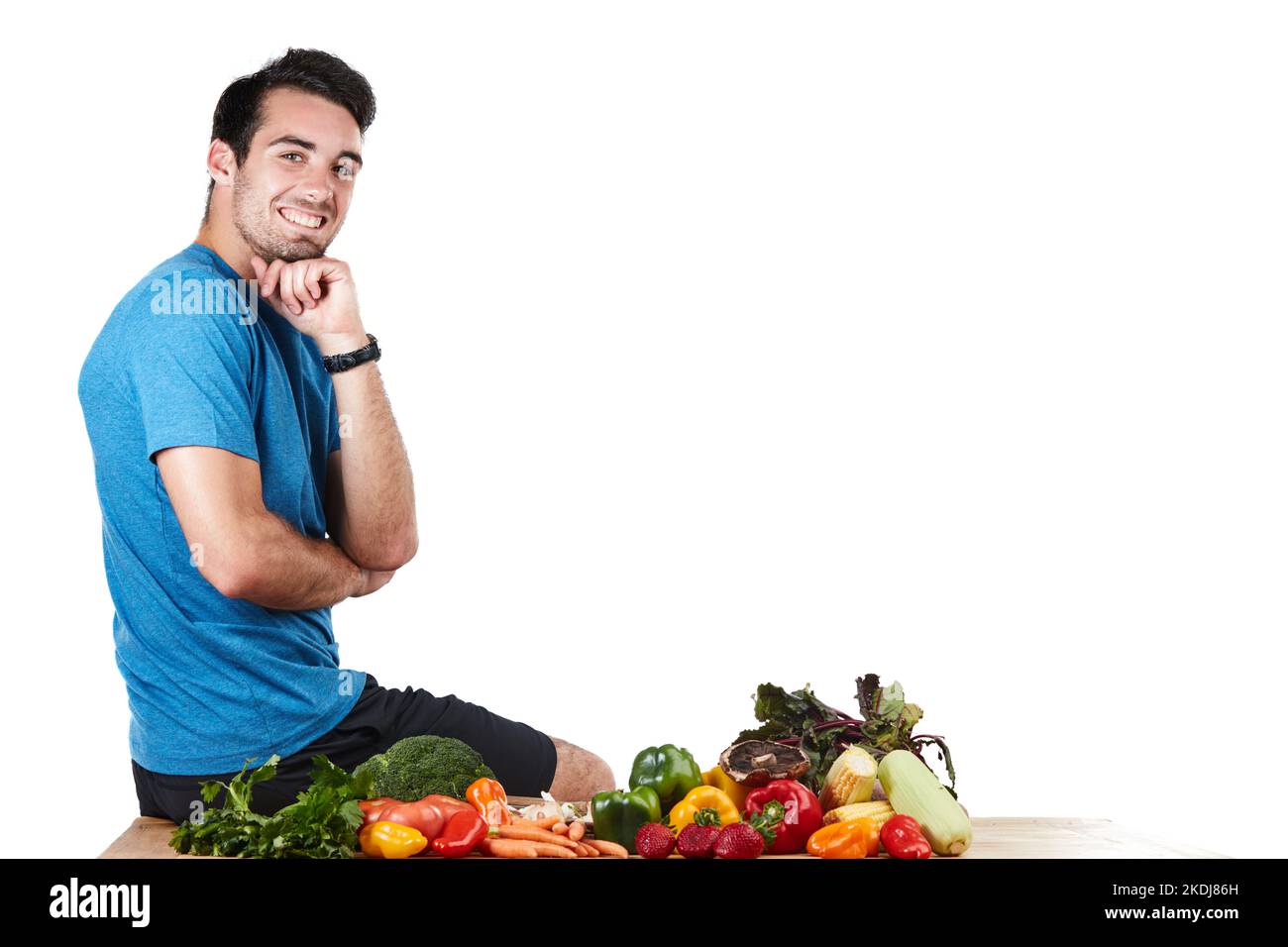 I like to keep a lot of fresh veg around. Studio portrait of a handsome ...
