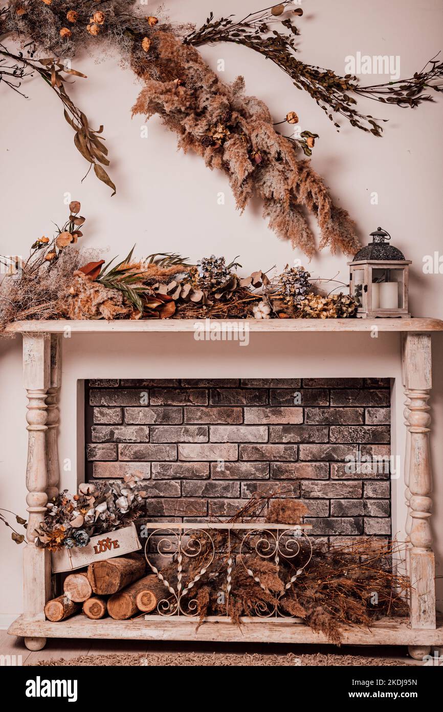 Fireplace decorated with dried flowers in the living room. Home ...