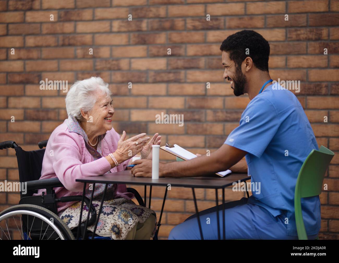 Young nurse explaining elderly woman hi-res stock photography and ...
