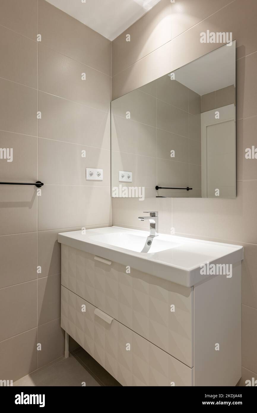 Modern empty bathroom with beige tiles, furniture and rectangular ...