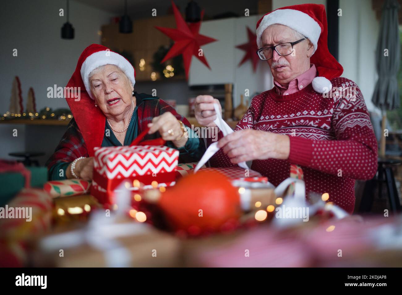 Senior couple celebrating Christmas, giving gifts each other Stock ...
